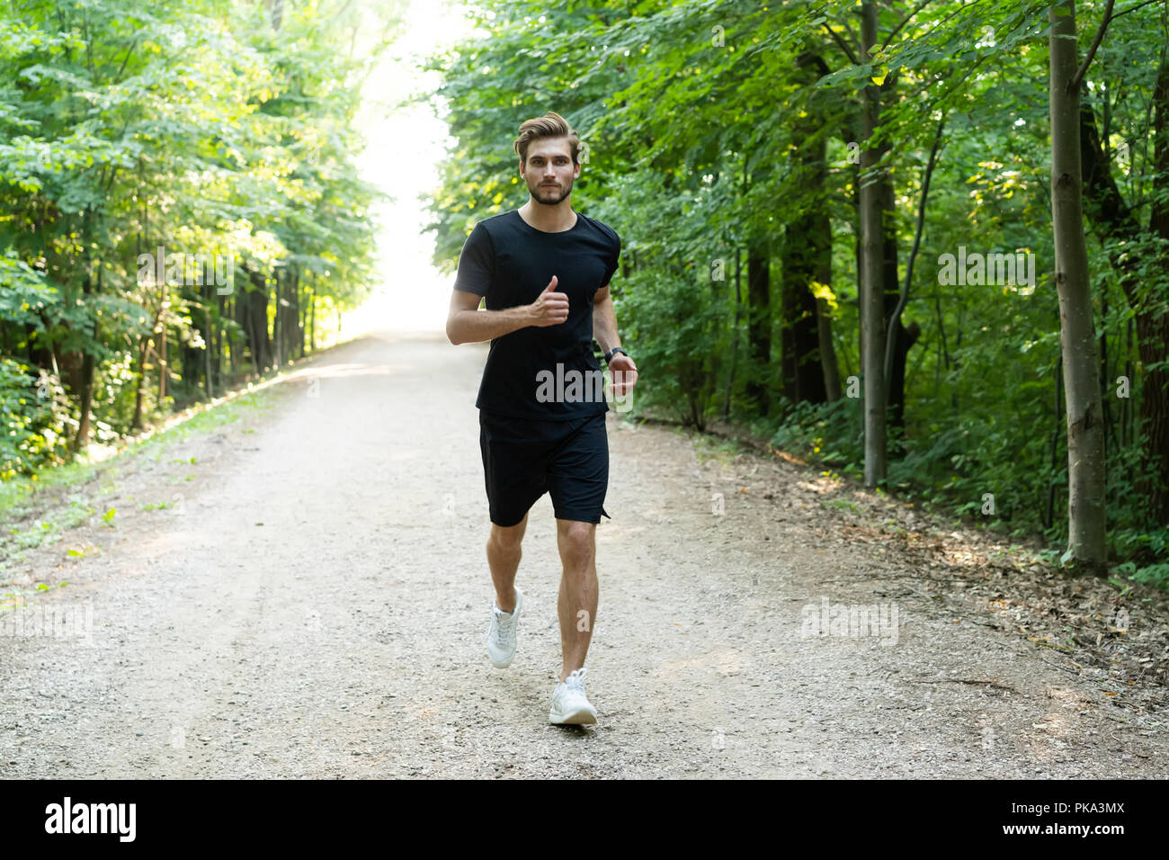 Athletic young man running in the nature. Healthy lifestyle Stock Photo ...