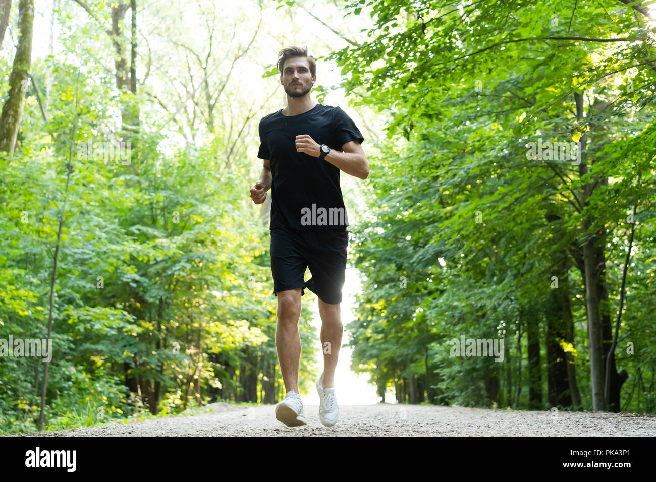 Athletic young man running in the nature. Healthy lifestyle Stock Photo ...