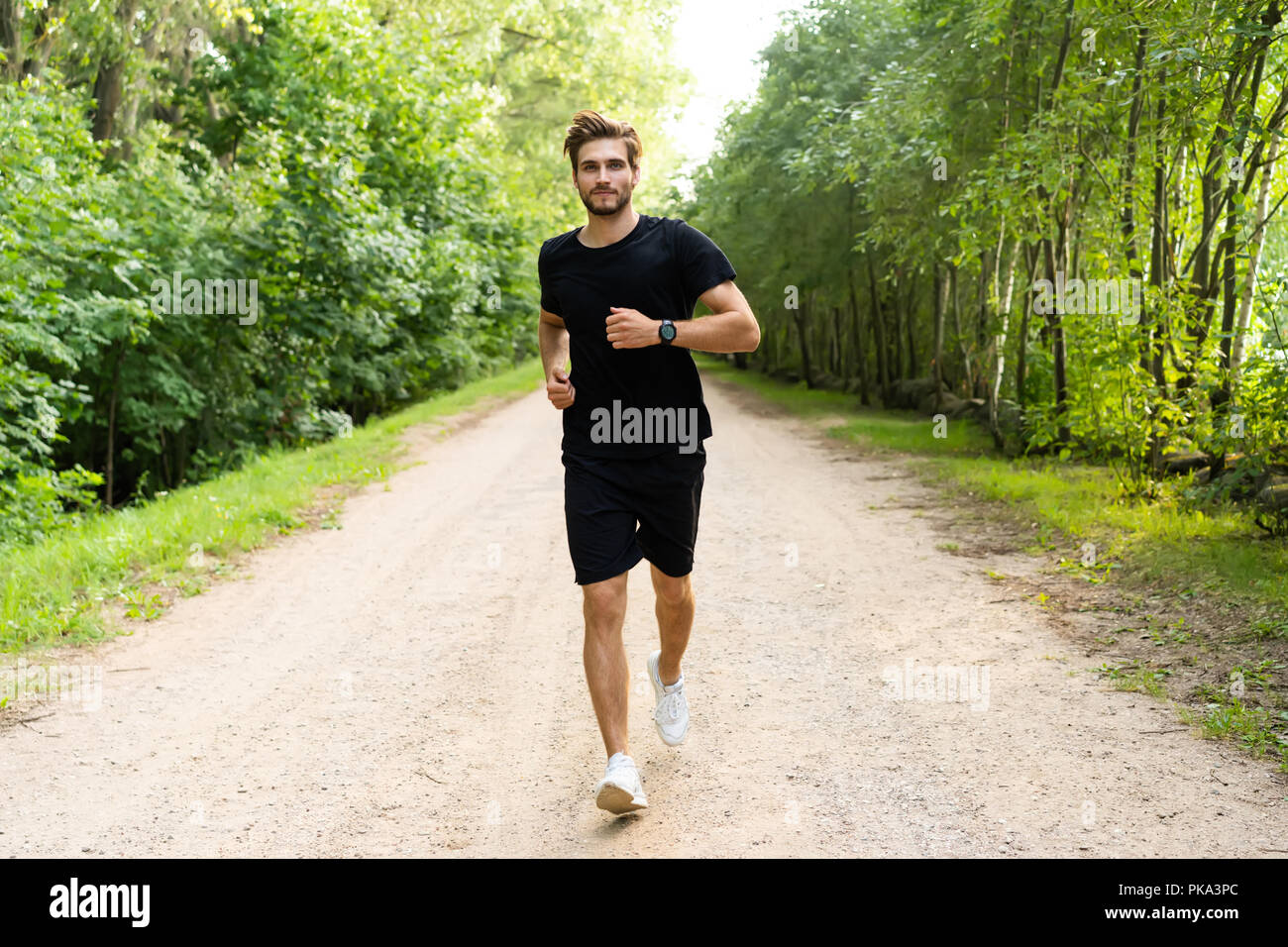 Athletic young man running in the nature. Healthy lifestyle Stock Photo ...