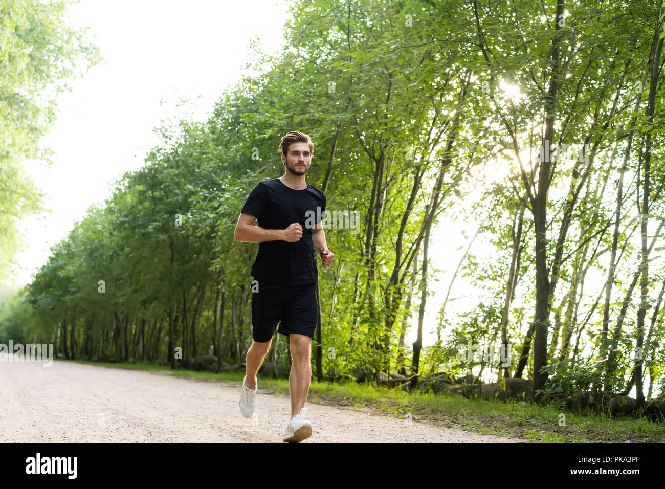 Athletic young man running in the nature. Healthy lifestyle Stock Photo ...
