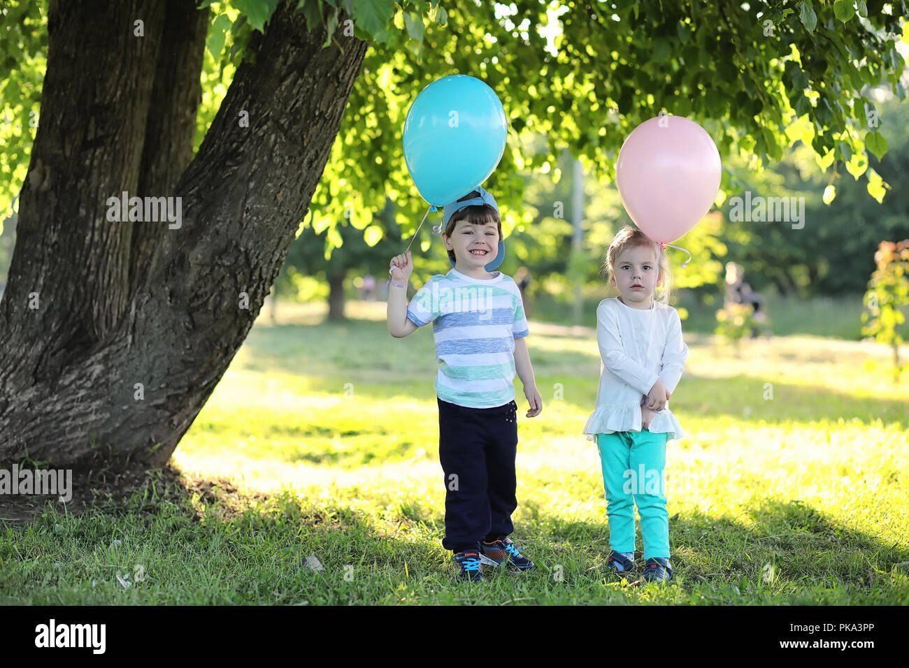 Little children are walking in a park Stock Photo - Alamy