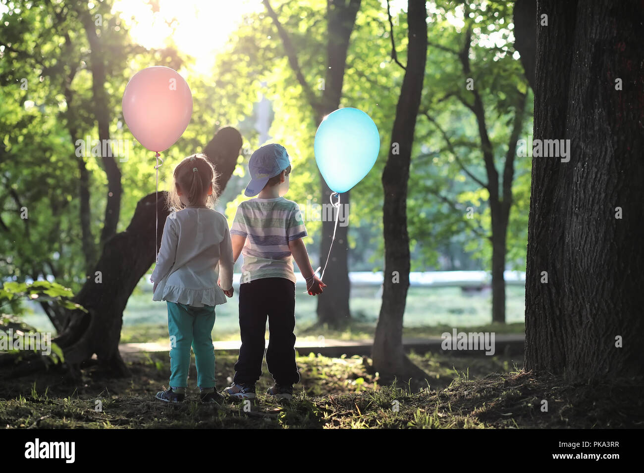 Little children are walking in a park Stock Photo - Alamy