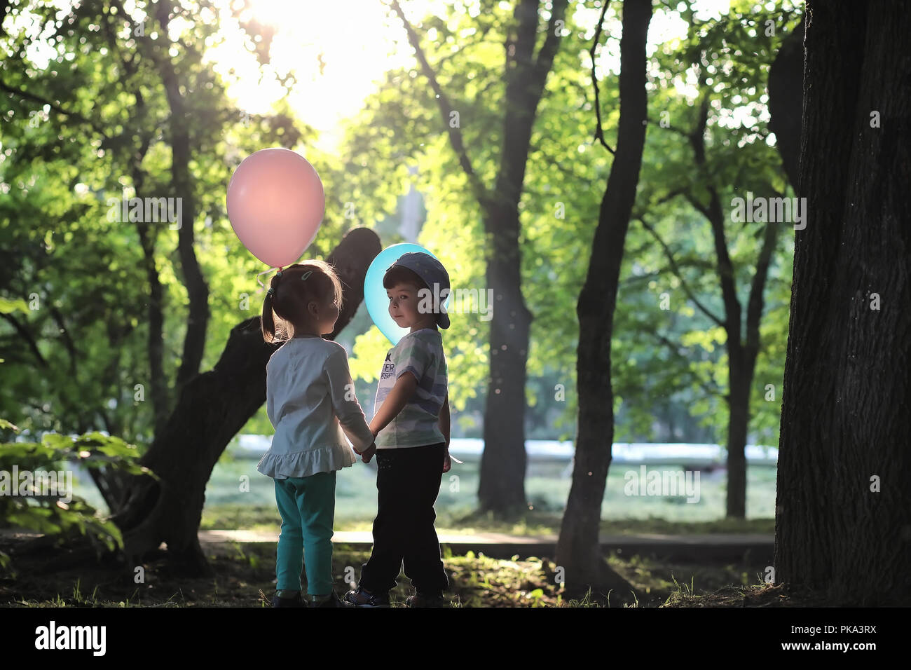 Little children are walking in a park Stock Photo - Alamy
