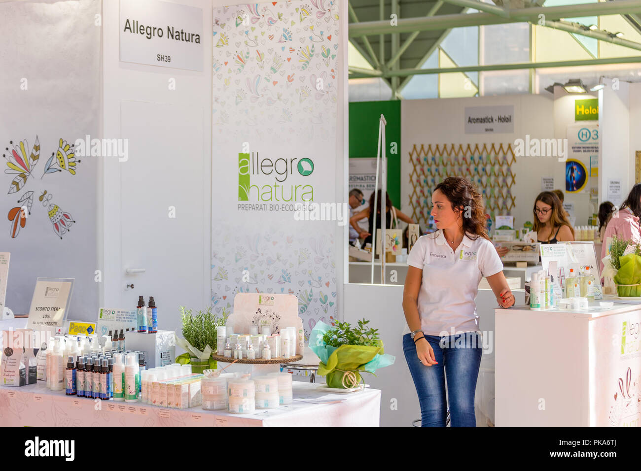 BOLOGNA (ITALY), SEPTEMBER 10, 2018: Booth presenter awaiting visitors ...
