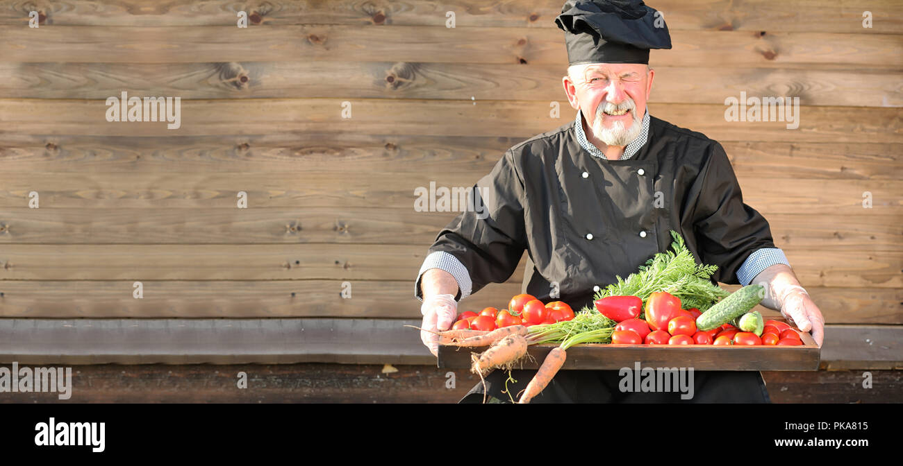 Chef old in uniform with vegetables Stock Photo - Alamy