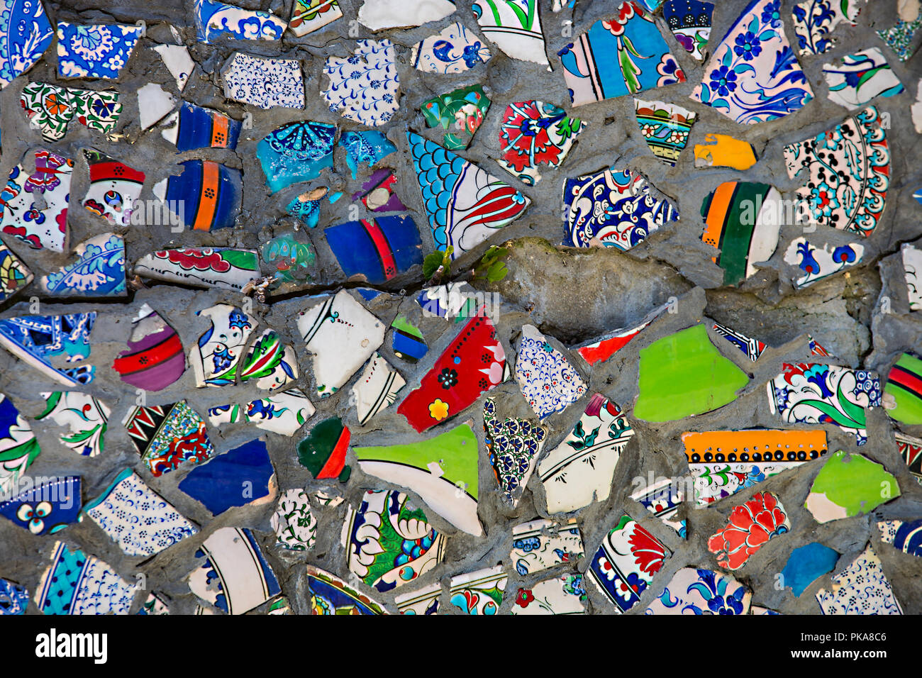 Wall with broken ceramic plates colored fragments Stock Photo - Alamy