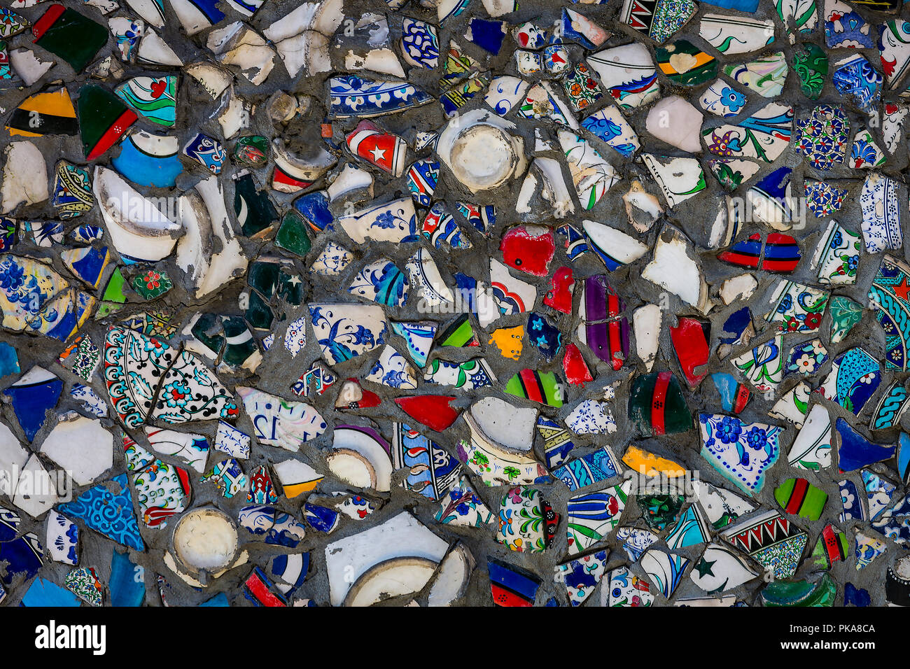 Wall with broken ceramic plates colored fragments Stock Photo - Alamy