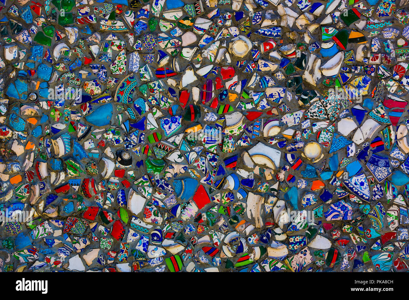 Wall with broken ceramic plates colored fragments Stock Photo - Alamy