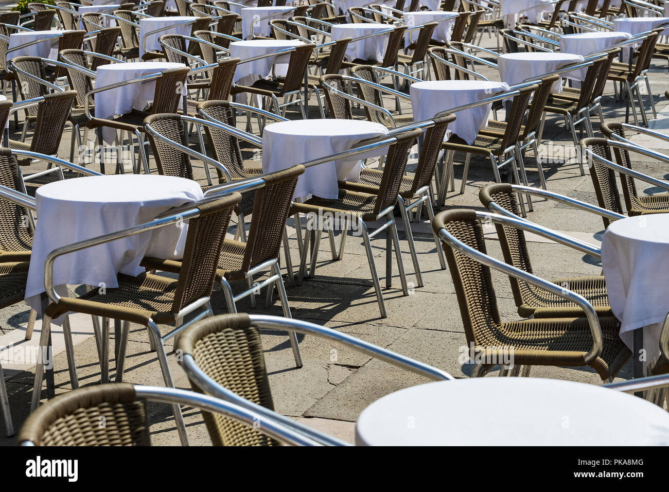 Rows of tables and chairs on the street in a restaurant Stock Photo - Alamy