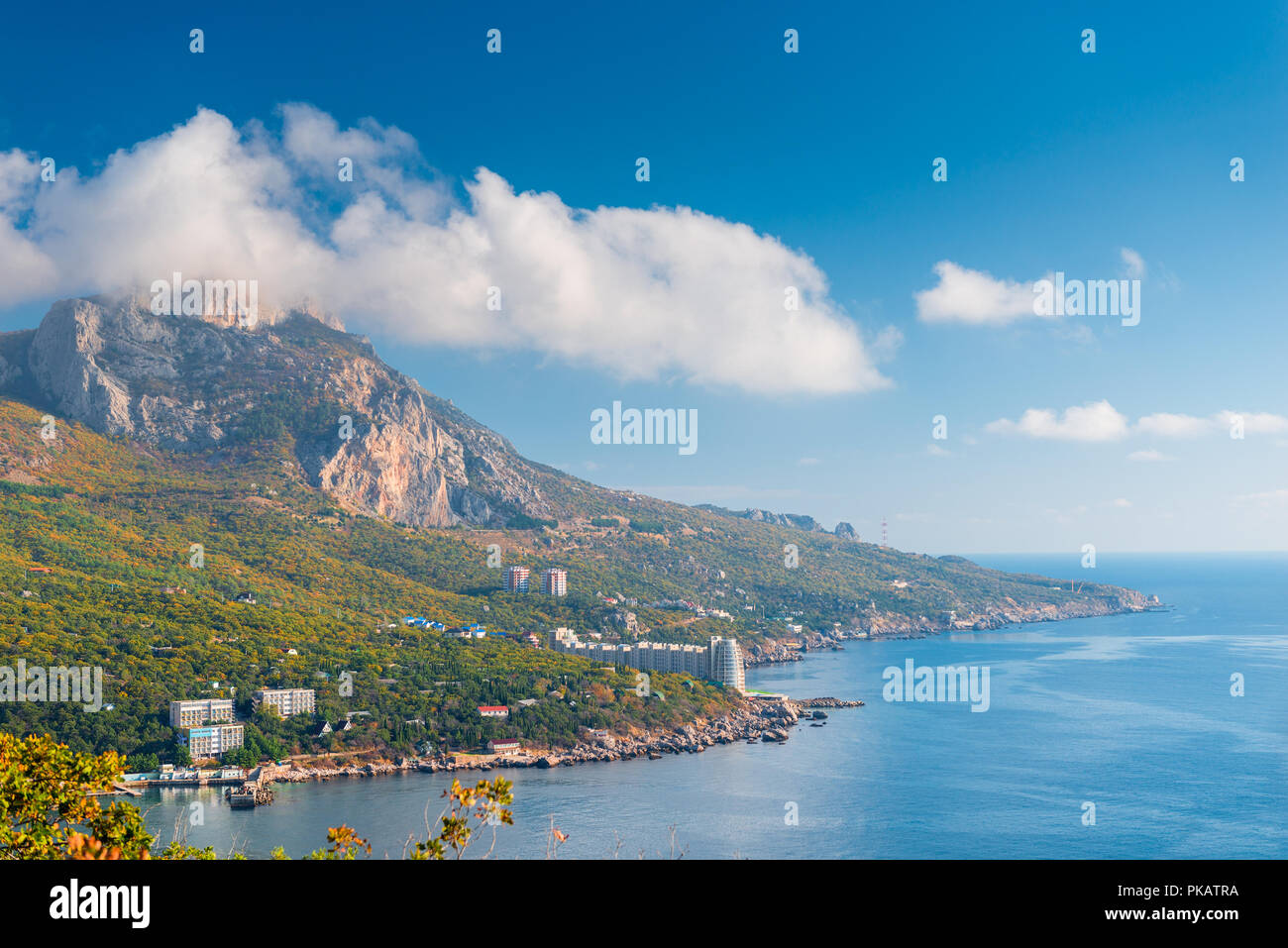 Mountain, covered with clouds against the blue seaThe picturesque bay ...