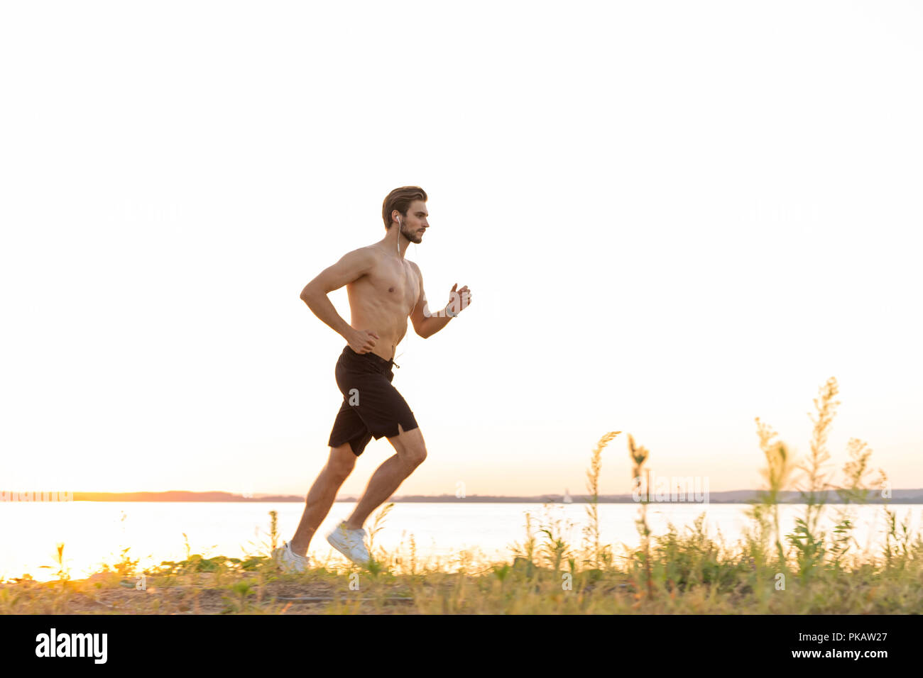 Athletic young man running in the nature. Healthy lifestyle Stock Photo ...