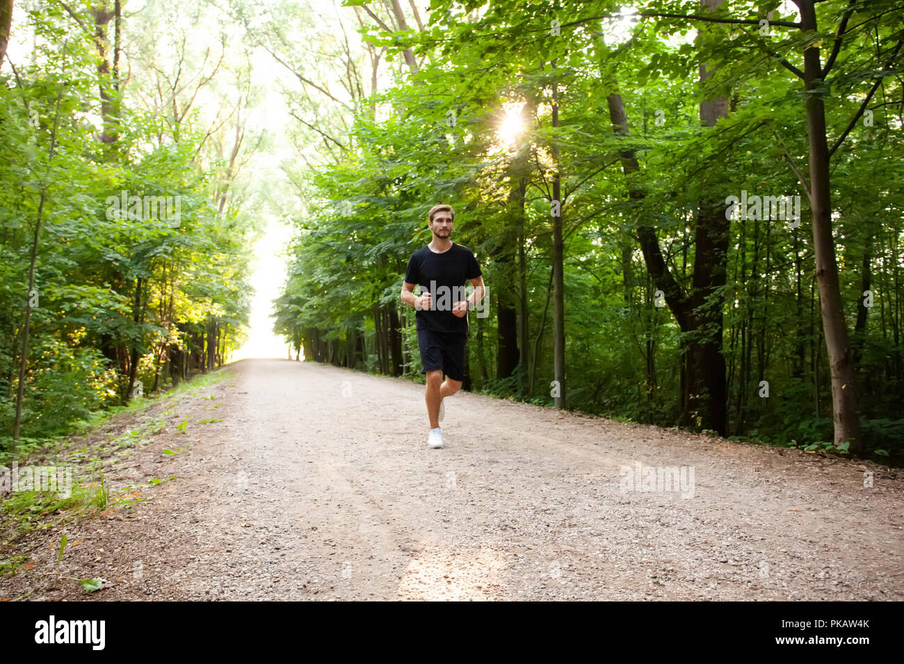 Athletic young man running in the nature. Healthy lifestyle Stock Photo ...