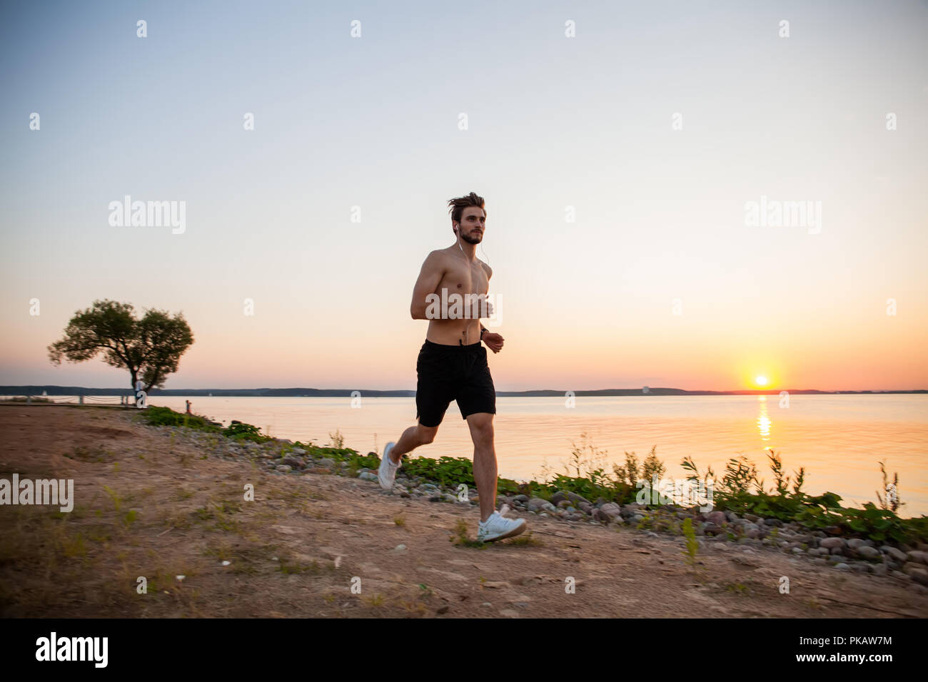 Athletic young man running in the nature. Healthy lifestyle Stock Photo ...