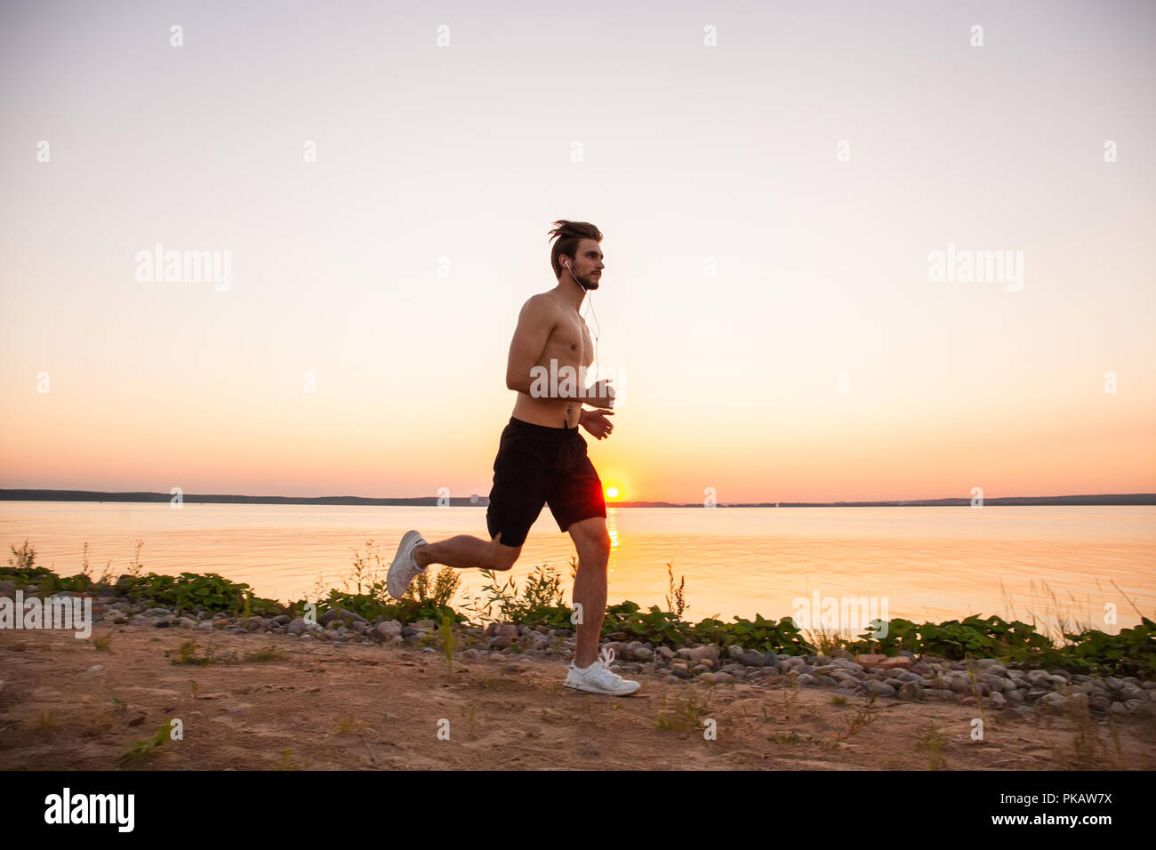 Athletic young man running in the nature. Healthy lifestyle Stock Photo ...
