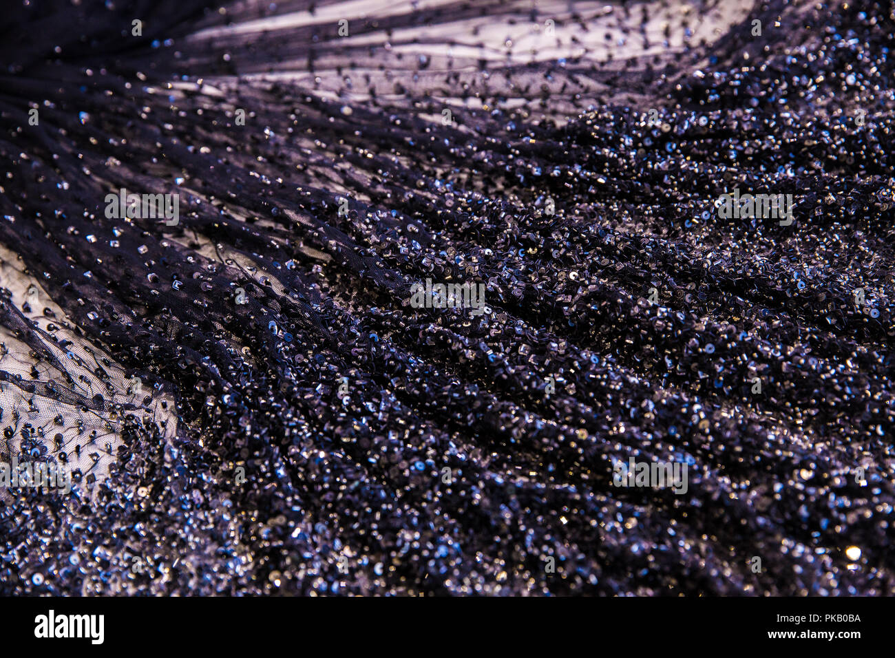 Black translucent fabric, beads on fabric, background, diagonal view ...