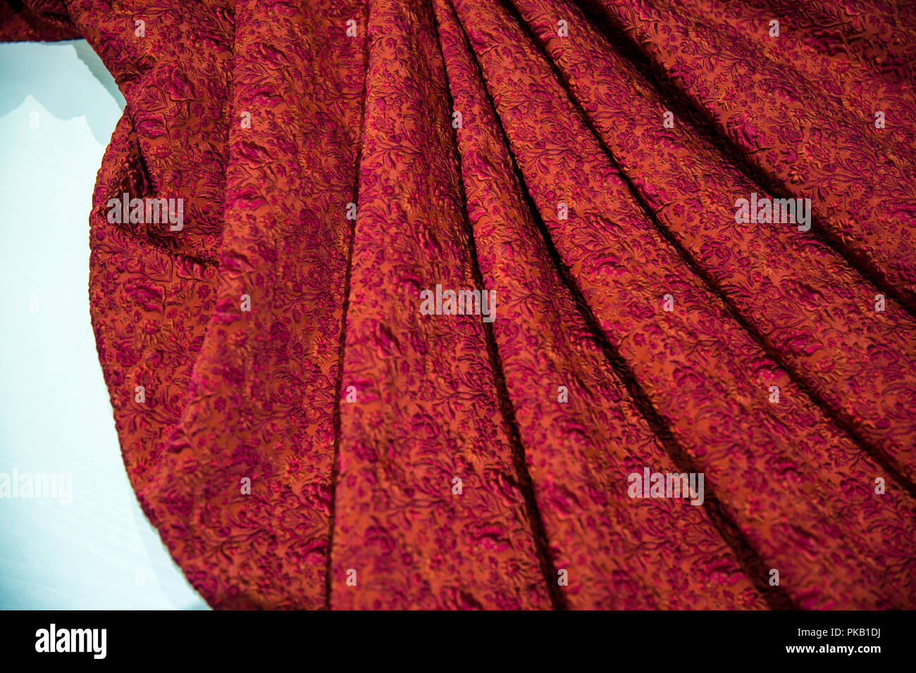 Red fabric for dresses, With flower patterns, fabric background, folds ...