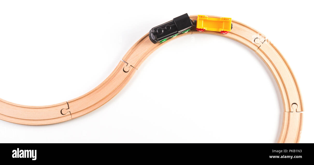 Toy train with curved wooden railways on white background. Top view ...