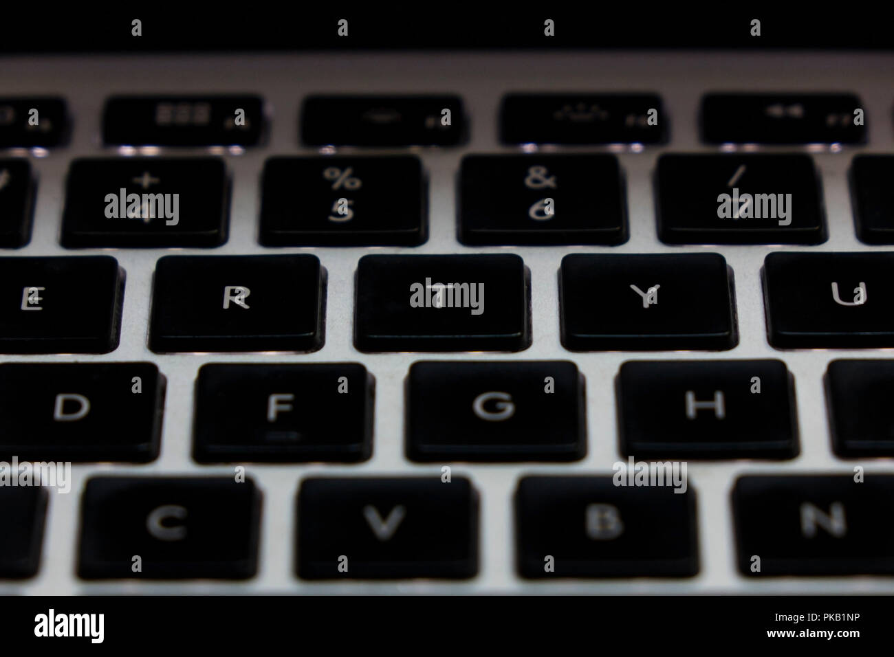 Detail illuminating the keyboard with a focus on Capslock Stock Photo ...