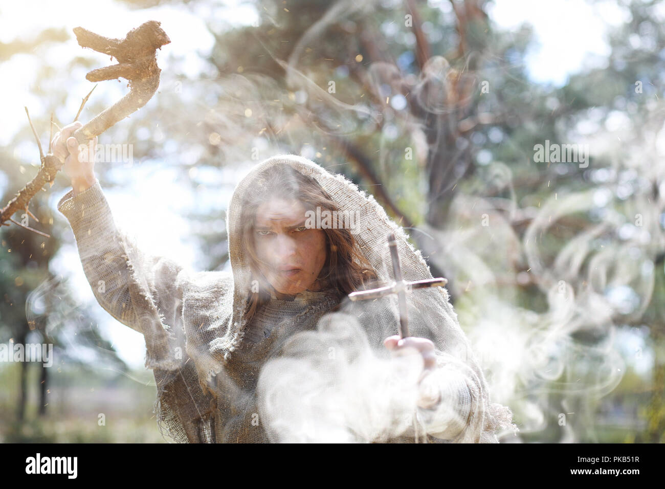 A man in a cassock spends a ritual in a dark forest Stock Photo - Alamy