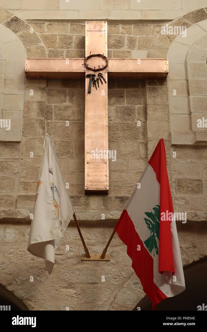 A cross placed over the Lebanese flag at the inner courtyard of the Mar ...