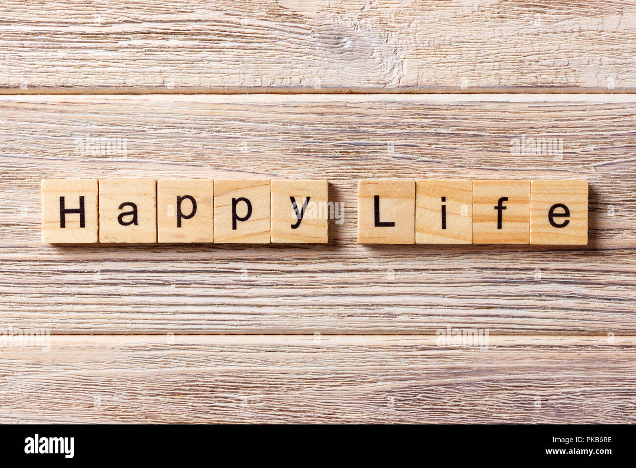 happy life word written on wood block. happy life text on table ...