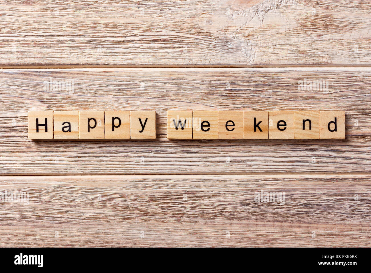 happy weekend word written on wood block. happy weekend text on table ...