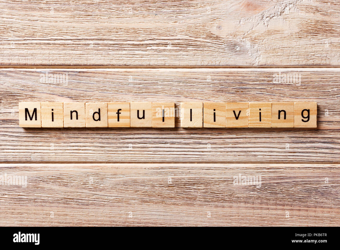mindful living word written on wood block. mindful living text on table ...