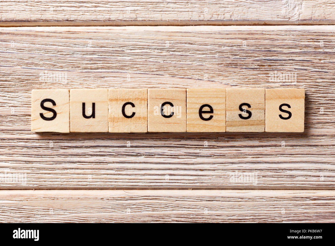 Success word written on wood block. Success text on table, concept ...