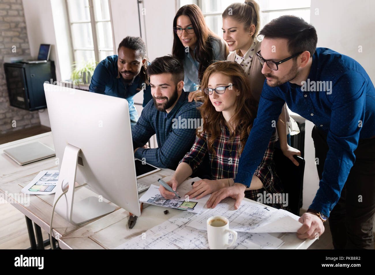Picture of architects working together in office Stock Photo - Alamy