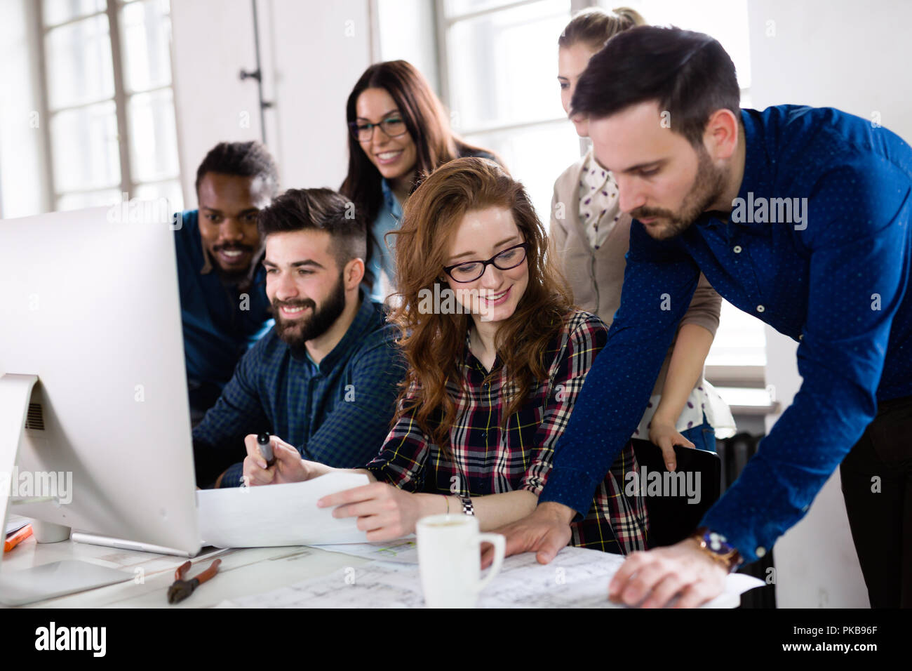 Picture of architects working together in office Stock Photo - Alamy