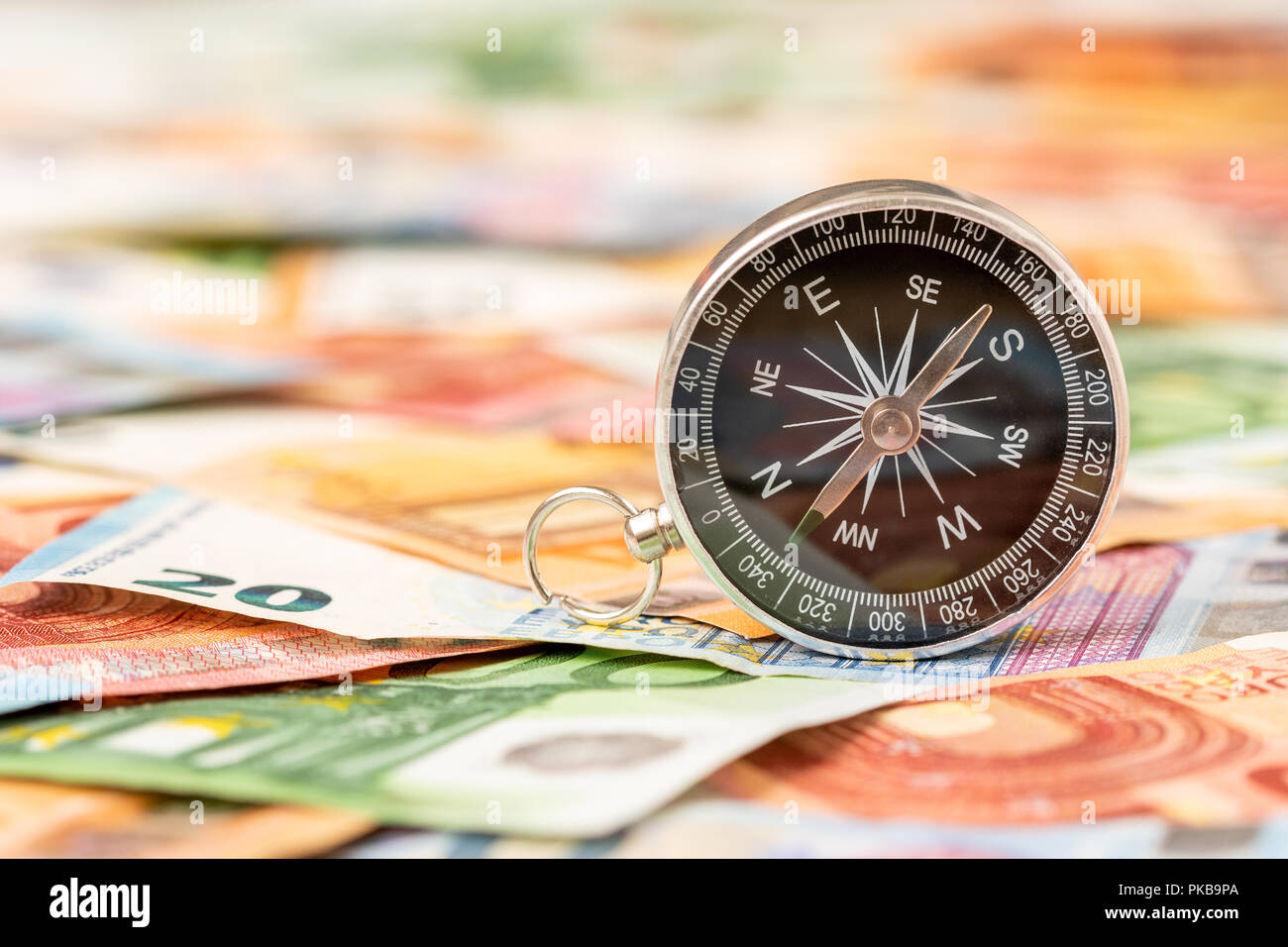 Magnetic compass on euro banknotes. Europe economy direction, financial ...