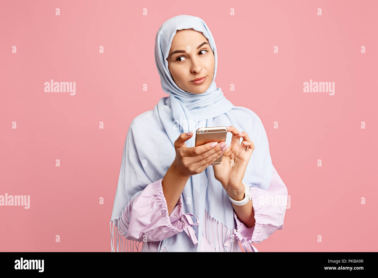 Happy arab woman in hijab with mobile phone. Portrait of smiling girl ...