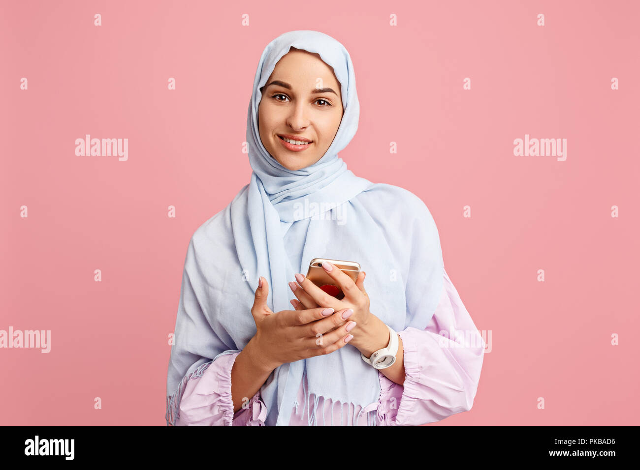Happy arab woman in hijab with mobile phone. Portrait of smiling girl ...