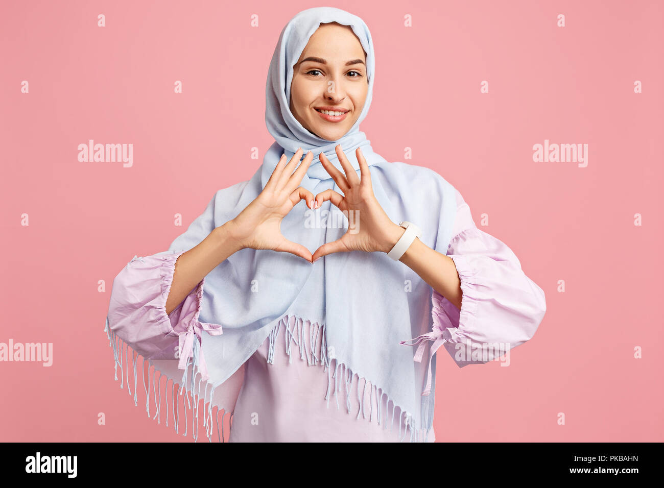 Happy arab woman in hijab. Portrait of smiling girl, posing at pink ...