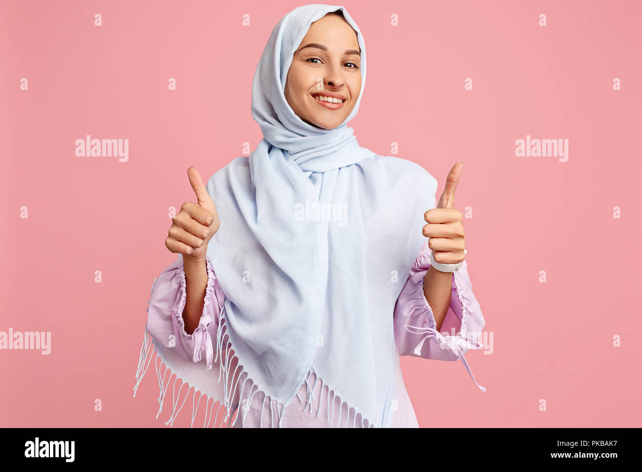 Happy arab woman in hijab with sign ok. Portrait of smiling girl ...