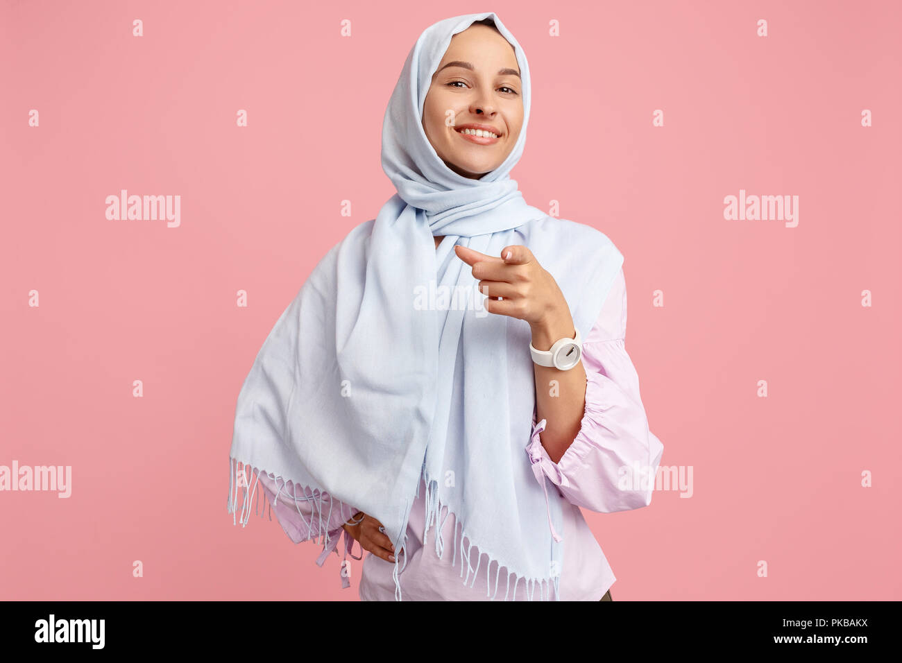 Happy arab woman in hijab pointing to camera. Portrait of smiling girl ...