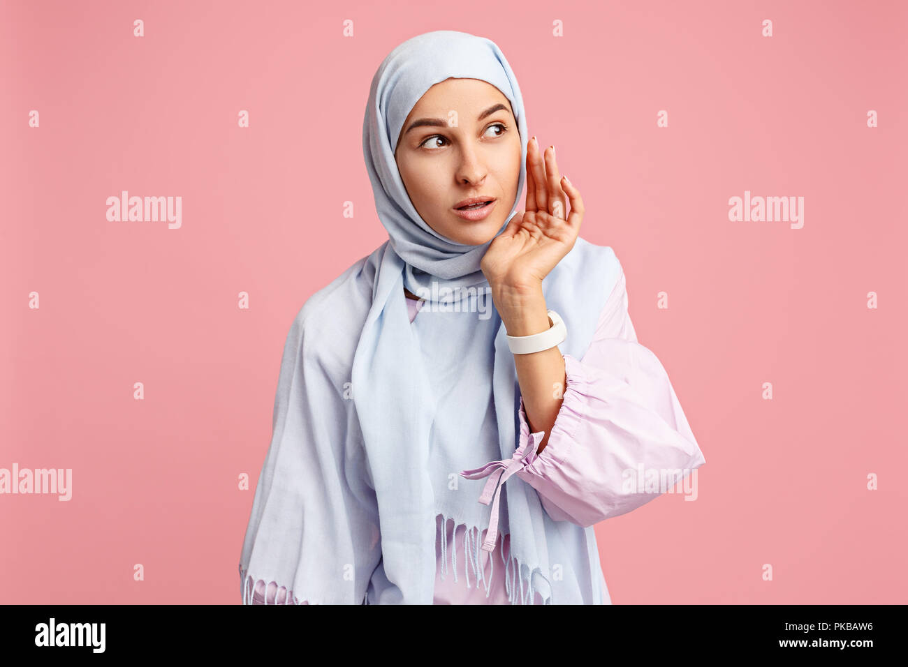Secret, gossip concept. Happy arab woman in hijab. Portrait of smiling ...