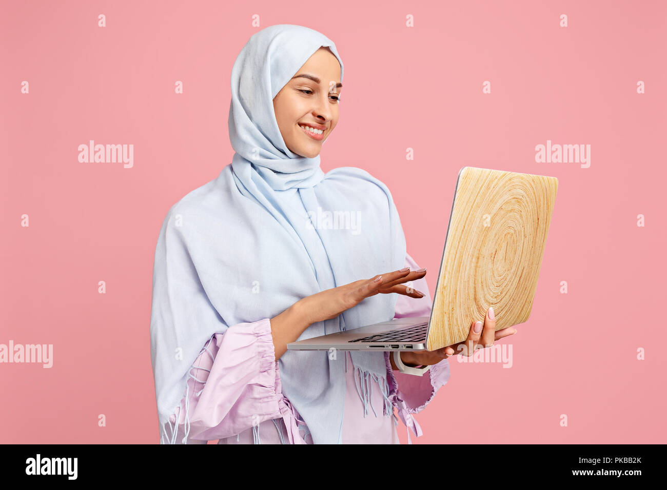 Happy arab woman in hijab with laptop. Portrait of smiling girl, posing ...
