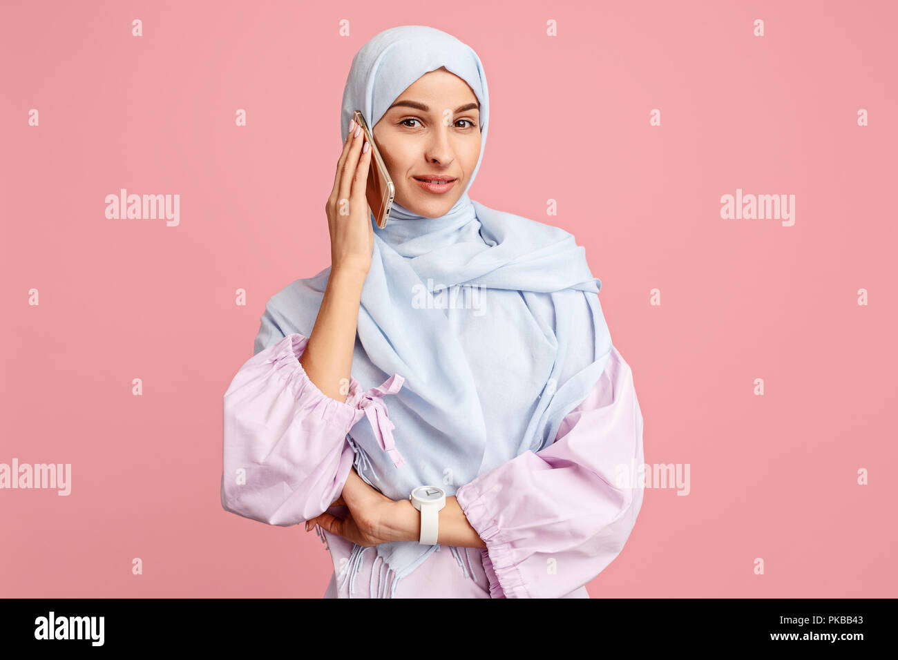 Happy arab woman in hijab with mobile phone. Portrait of smiling girl ...