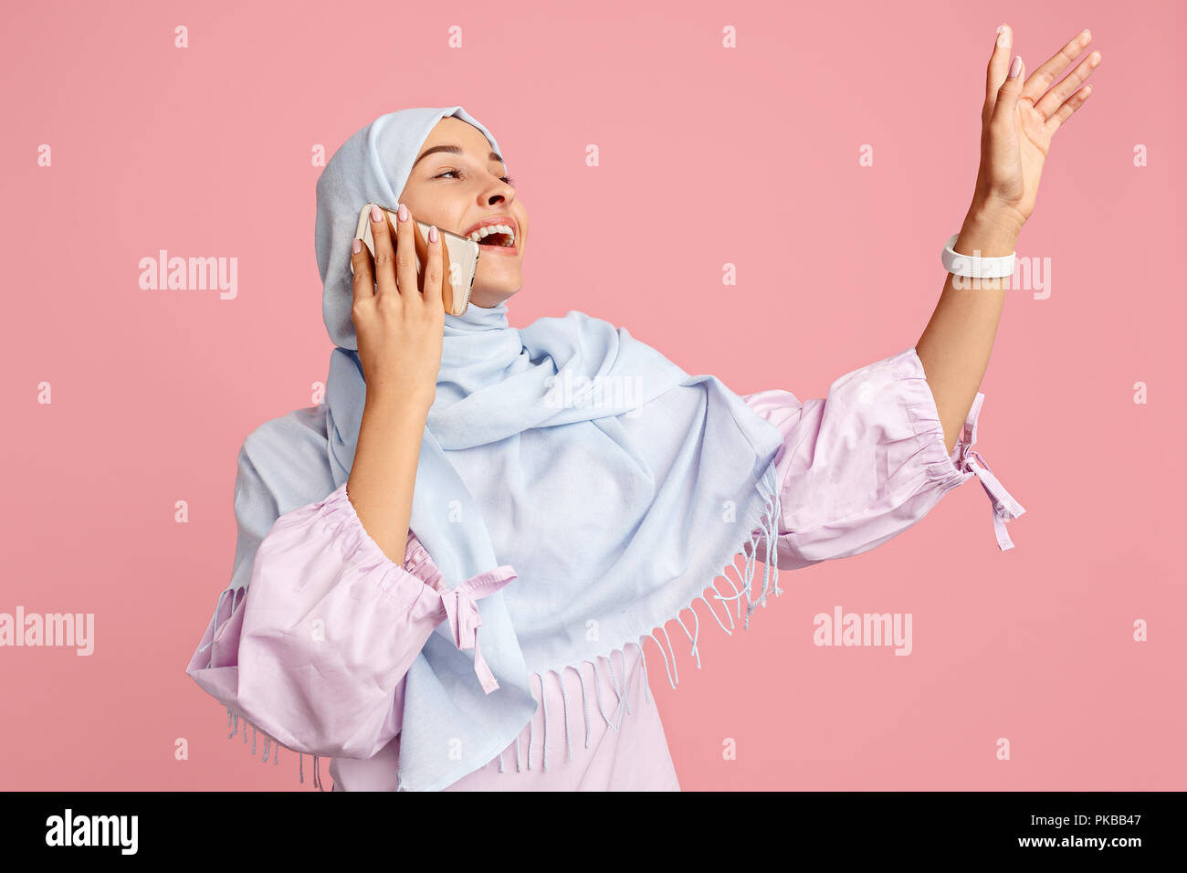 Happy arab woman in hijab with mobile phone. Portrait of smiling girl ...
