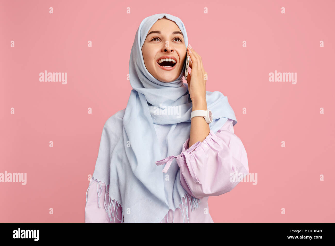 Happy arab woman in hijab with mobile phone. Portrait of smiling girl ...