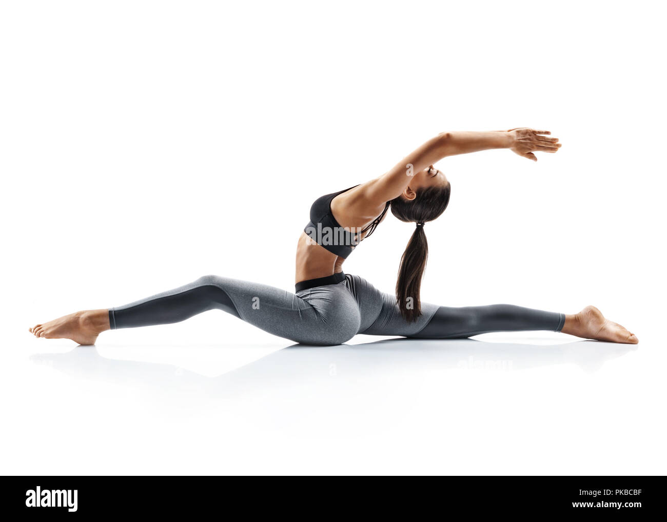 Young girl practice balance asanas isolated on white background ...