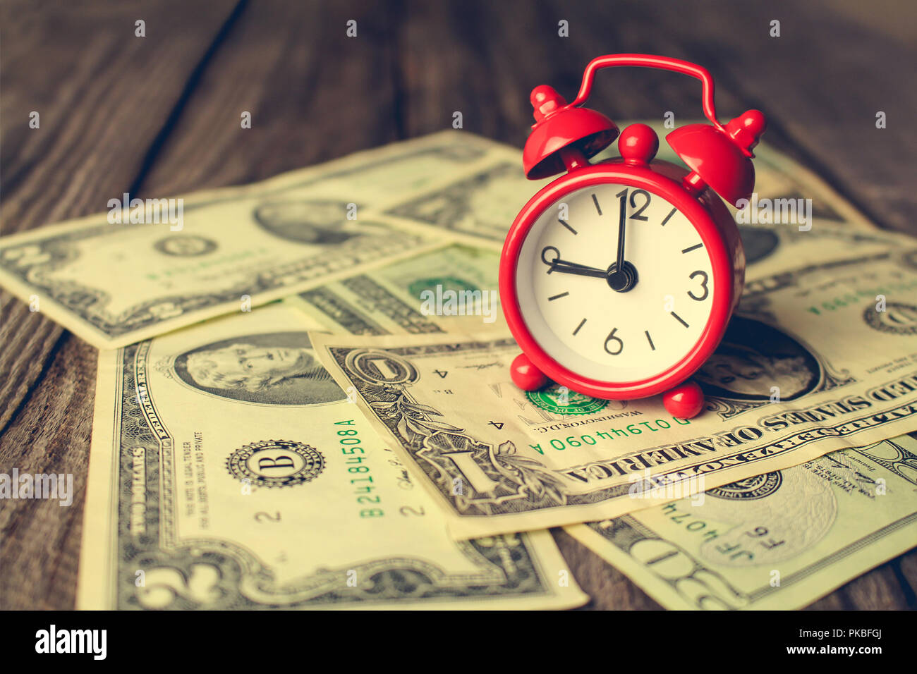 Clock on background of dollars. Concept of money is time. Toned image ...