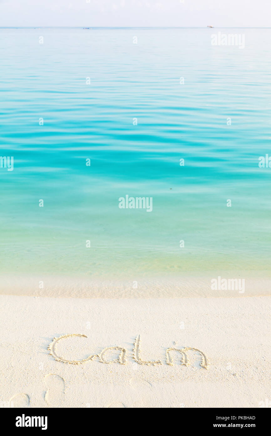 The Word Calm Written in the Sand on a Beach with morning sea ...