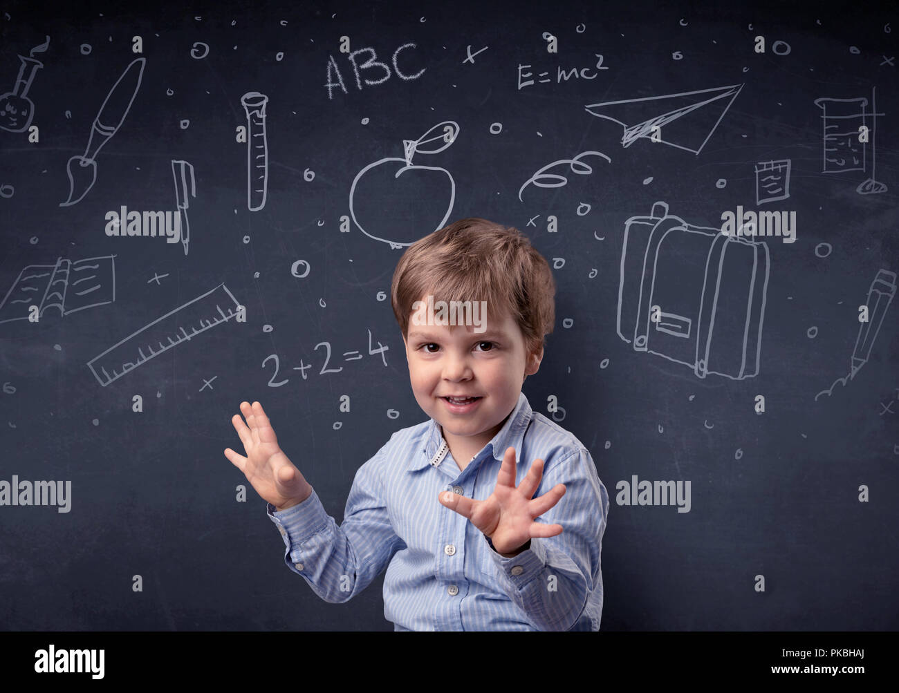 Smart little kid in front of a drawn up blackboard ruminate Stock Photo ...
