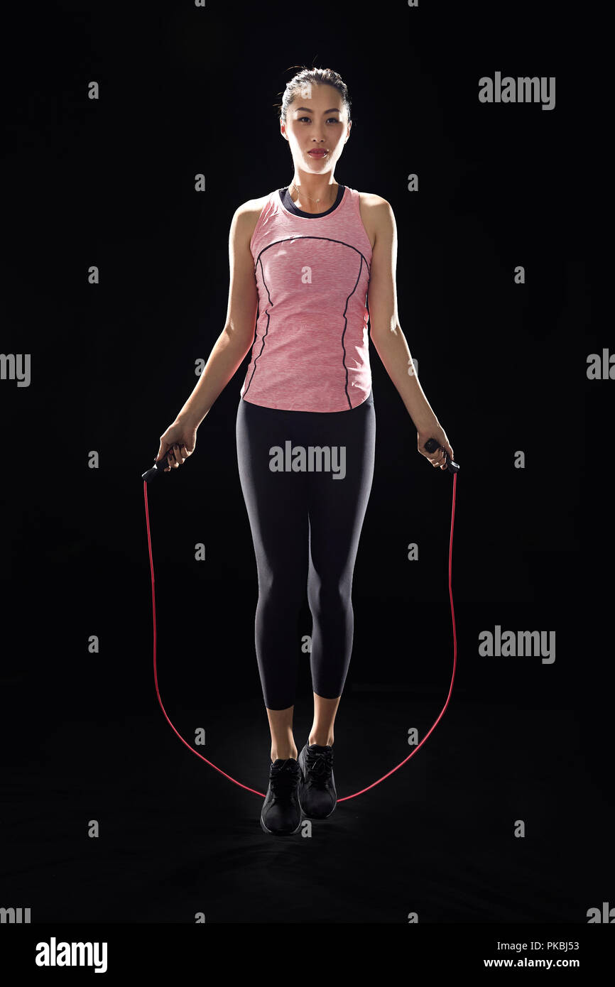 Young woman jumping rope Stock Photo - Alamy