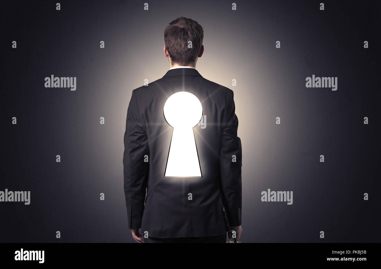 Young businessman standing and thinking with black keyhole on his back ...