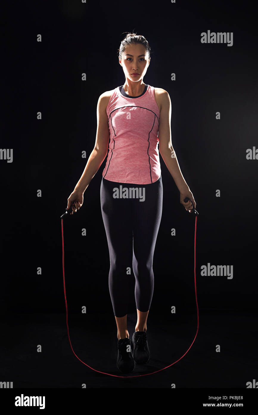 Young woman jumping rope Stock Photo - Alamy