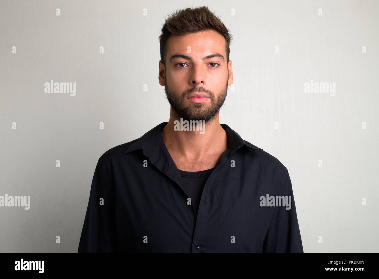 Studio shot of young handsome bearded businessman Stock Photo - Alamy