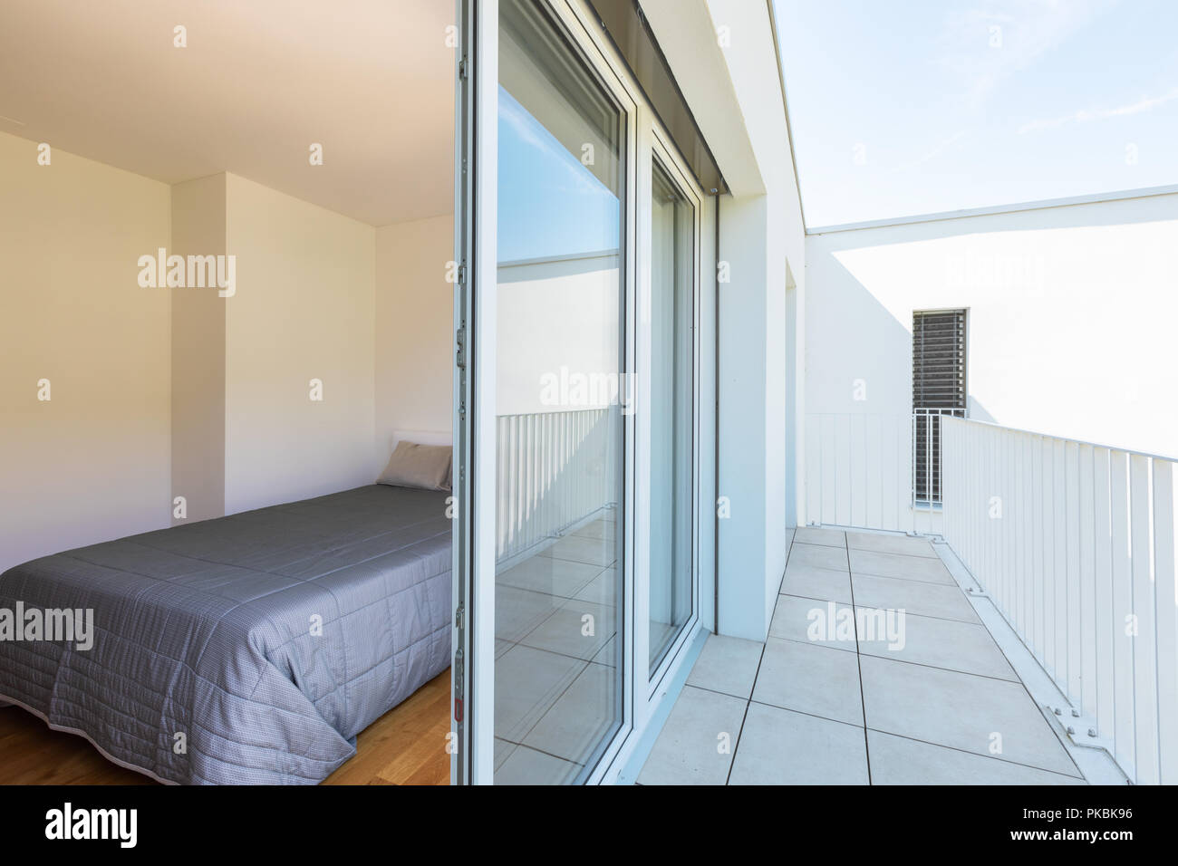 Balcony and bedroom together with a window open Stock Photo - Alamy